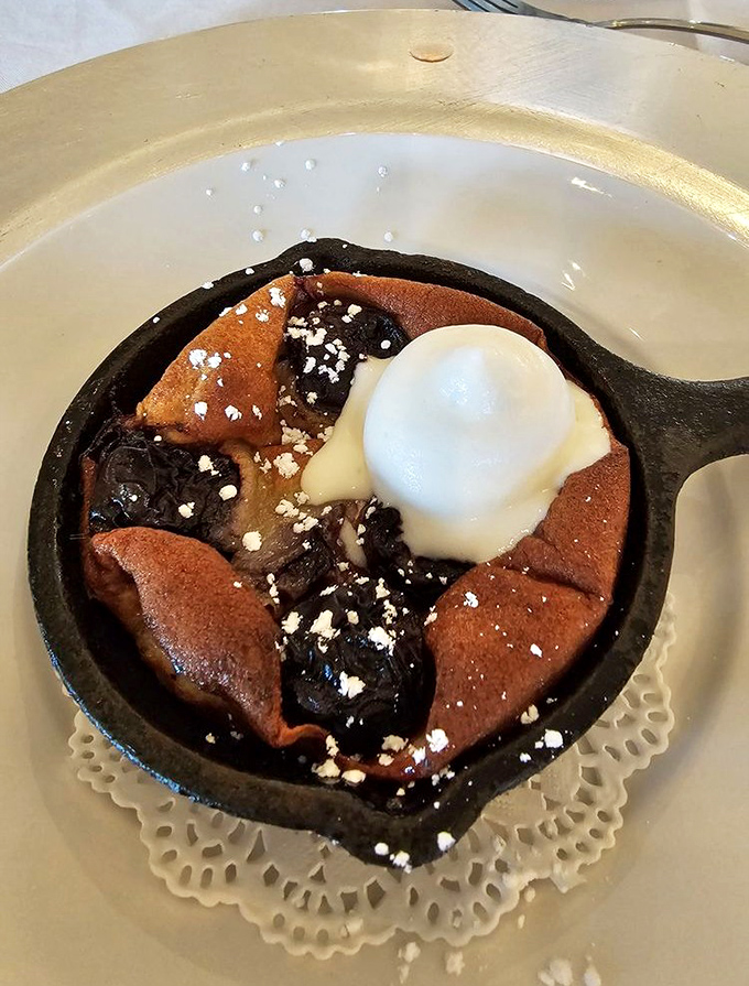 Not your average cobbler! This cast-iron cherry dessert arrives bubbling hot with a scoop of vanilla ice cream melting into its sweet depths.