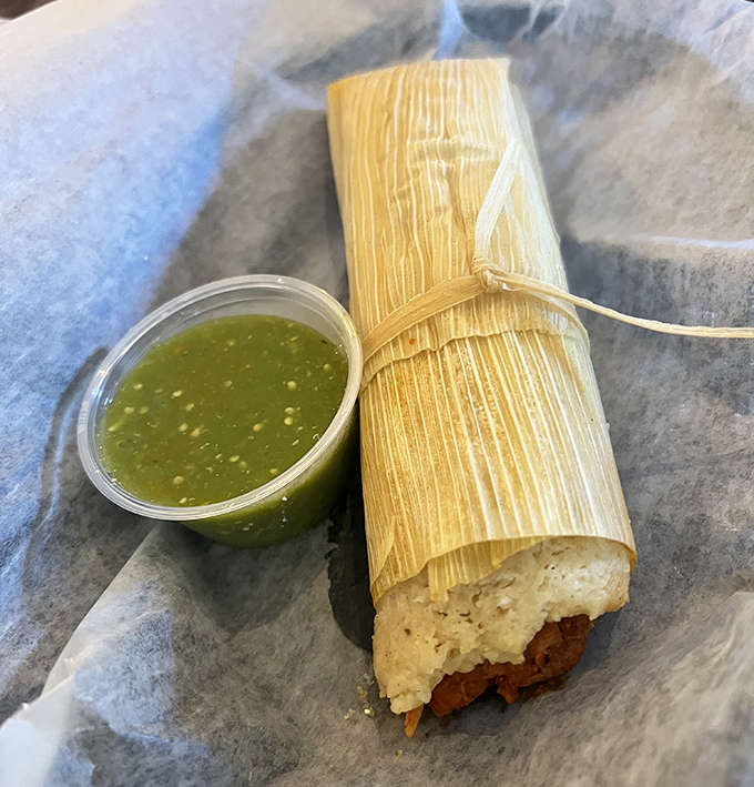 These tamales arrive like little gifts, still wrapped and ready to reveal their steamy, savory secrets with each careful unwrapping.