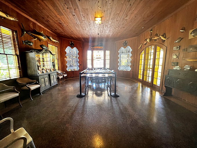 The dining room stands ready for phantom guests, wooden ceilings hovering above like an upside-down ship's hull.
