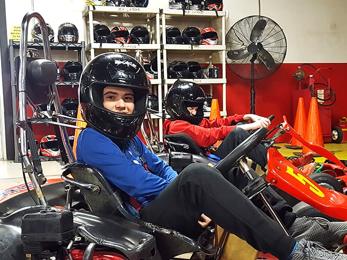 Safety first! Racers suit up with proper helmets before hitting the track for their high-speed adventure.