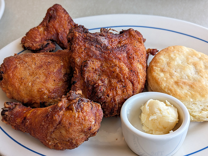 Southern hospitality on a plate: perfectly fried chicken alongside a buttery biscuit and honey butter that'll make you question all other bread products.