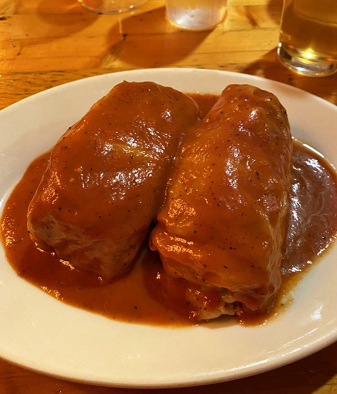 Golabki &ndash; where cabbage leaves embrace savory fillings before taking a luxurious bath in rich tomato sauce. Comfort food, elevated.