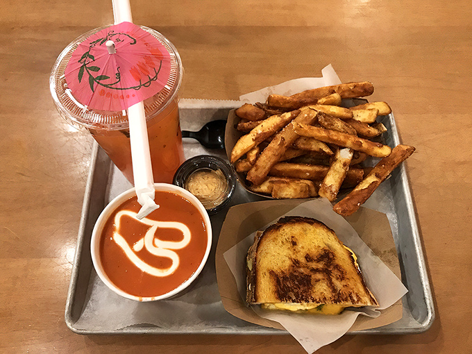 Melted cheese oozes from perfectly toasted bread alongside golden fries and tomato soup &ndash; comfort food elevated to an art form.