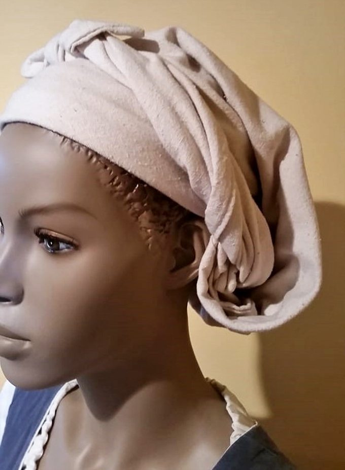 This period-appropriate headwear wasn't just fashion &ndash; it was practical protection from sun and social expectations.