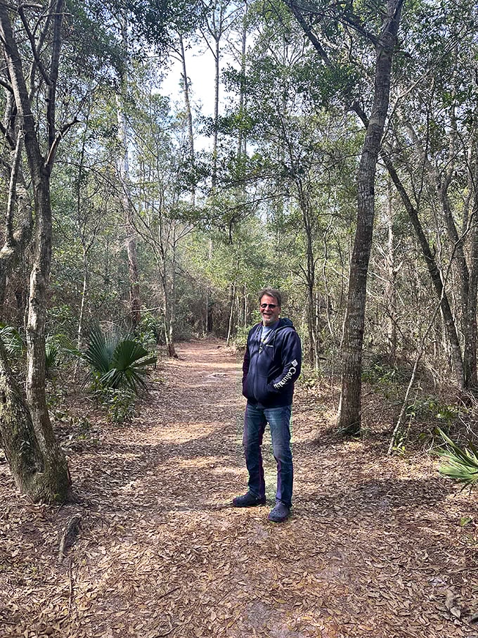 Dappled sunlight filters through the trees, creating a natural cathedral effect that makes even non-hikers pause in appreciation.