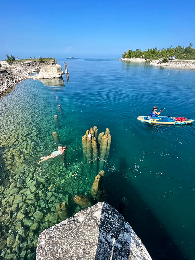 Kayaking: Paddlers glide across water so clear you can count fish below, while ancient limestone pillars stand guard like nature's own Stonehenge.