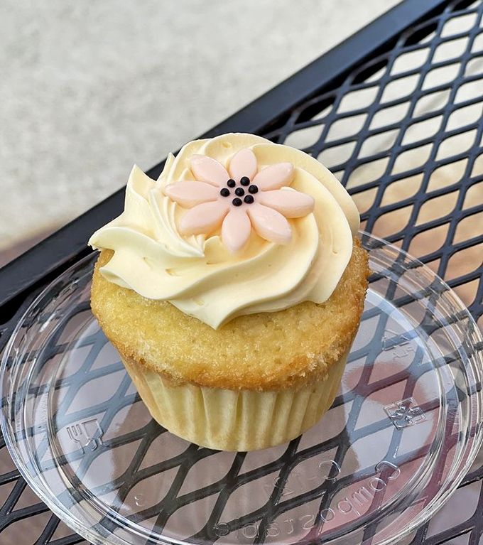 This isn't just any cupcake &ndash; it's a lemon passion fruit masterpiece topped with a delicate flower, proving dessert can be both beautiful and delicious.
