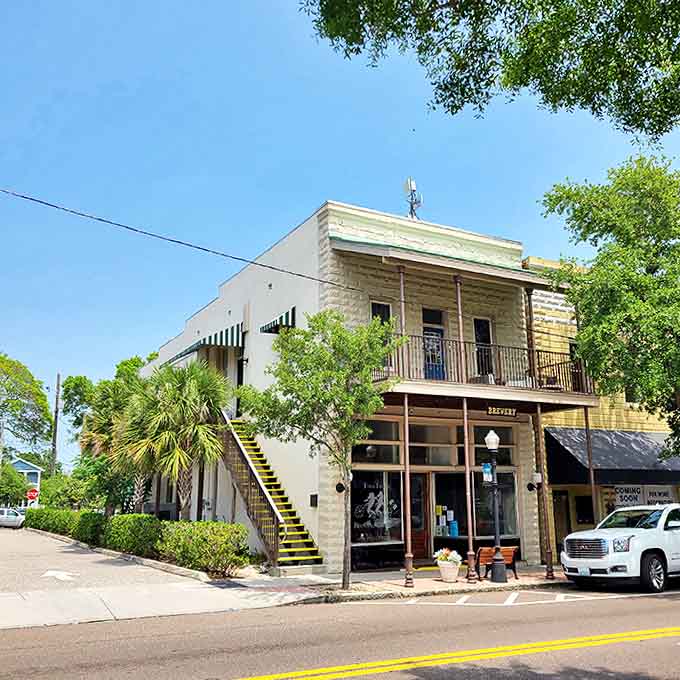 Historic limestone buildings with wrought-iron balconies house local businesses, preserving the town's authentic character against the tide of chain stores.