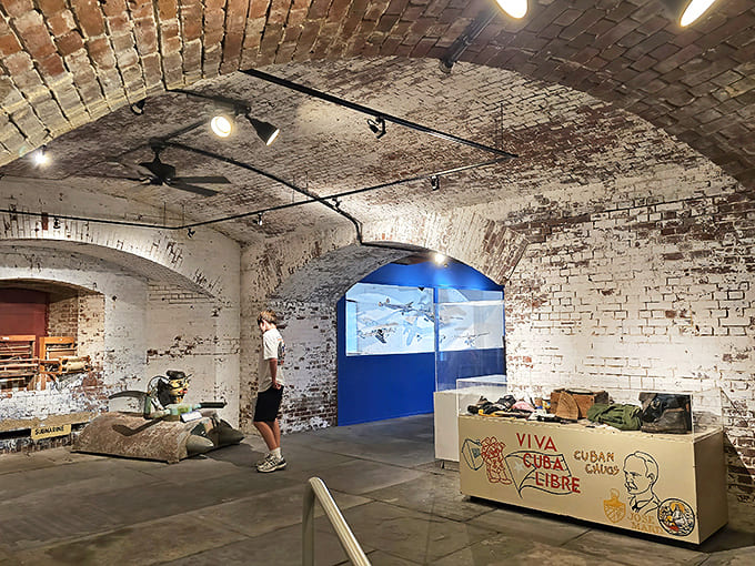 A visitor contemplates the displays in one of the museum's atmospheric chambers, where history and the supernatural seem to occupy the same space.
