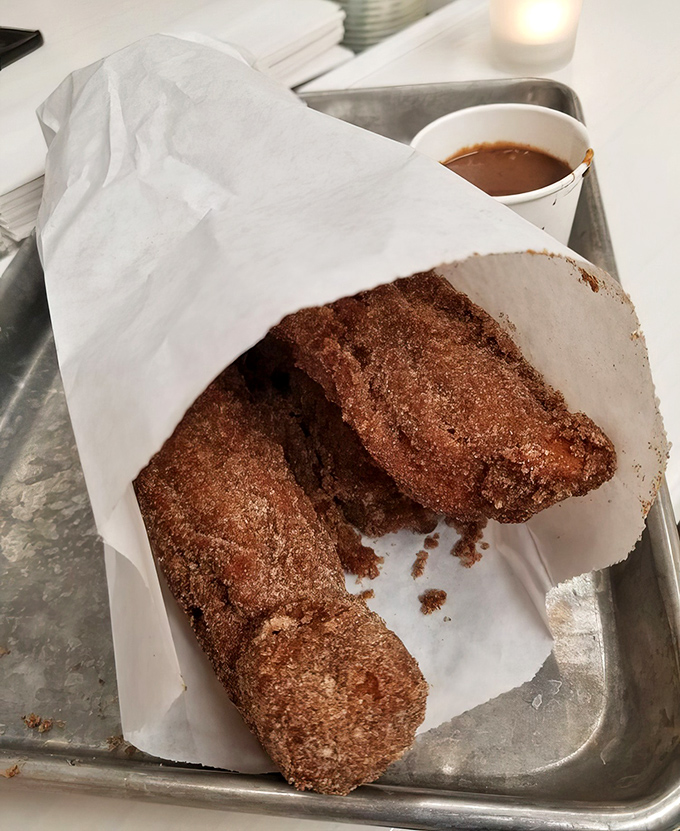 These aren't your carnival churros &ndash; these massive cinnamon-sugar wonders are what dessert dreams are made of, crispy outside and cloud-soft inside.