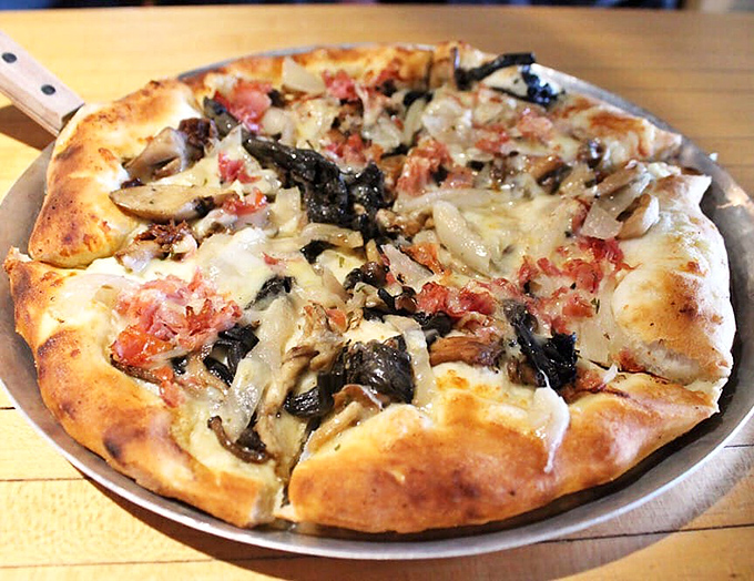 Mushrooms and other toppings create a landscape of flavors on this pie &ndash; like exploring an alien terrain where every bite reveals new discoveries.