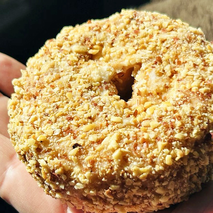 The "Nutty Cake" donut wears its crunchy peanut coating like armor, protecting the soft, sweet dough beneath – a textural masterpiece.