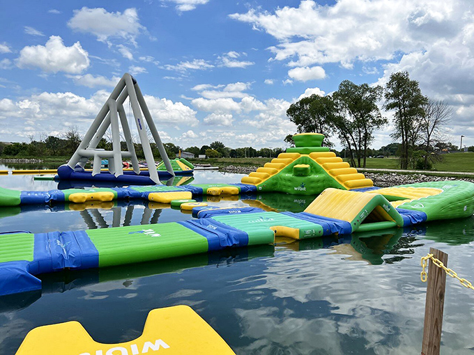 The perfect summer day: blue skies, clear water, and a floating playground that beckons to kids and adults alike.