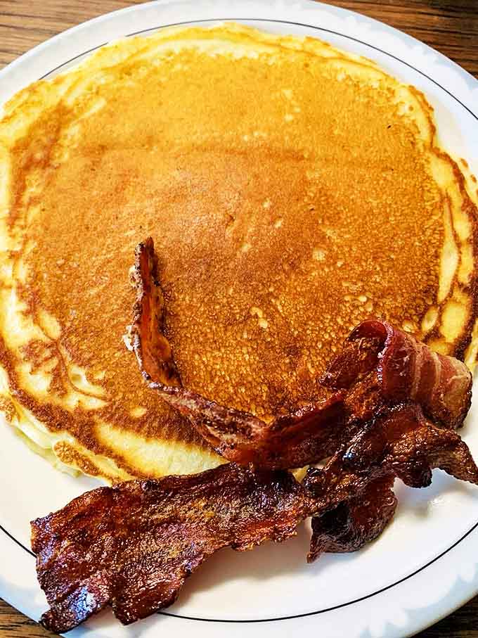 Golden pancakes with perfectly crisp bacon – breakfast doesn't get more beautiful than this simple yet transcendent combination.