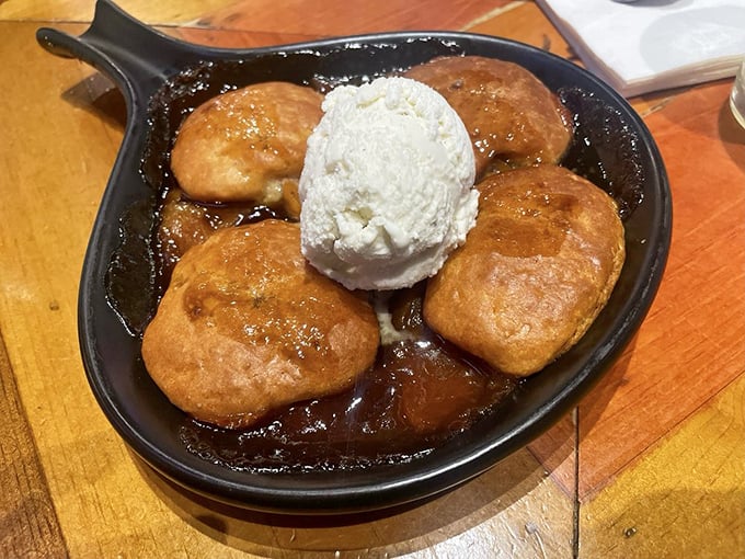 Sweet endings come in the form of this warm peach cobbler, where bubbling fruit meets cold vanilla ice cream in a cast-iron skillet of pure comfort.