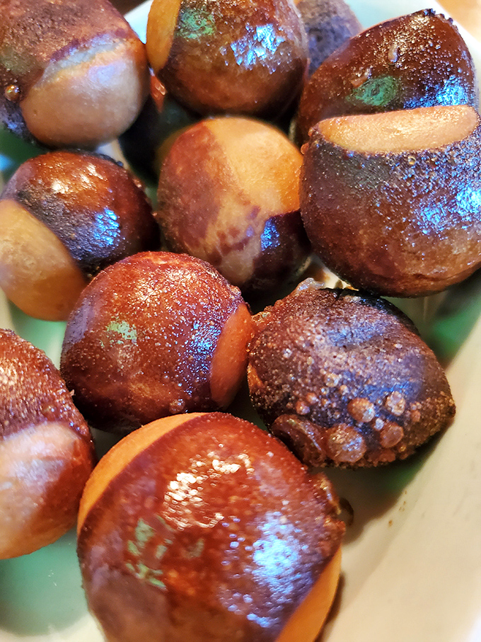 Golden-brown pretzel bites glisten with butter, their perfectly salted exteriors hiding soft, chewy centers waiting for a cheese dunk.