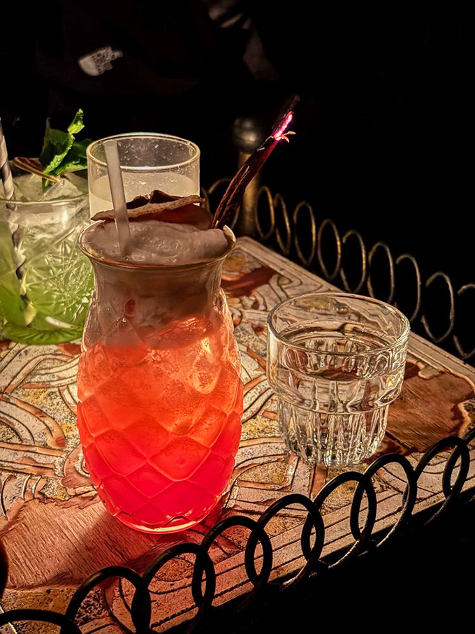 This vibrant ruby-colored concoction isn't just a drink, it's a conversation piece that arrives with theatrical flair and tastes even better than it looks.