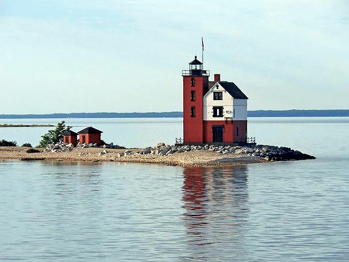On calm days, the lighthouse's reflection creates a perfect mirror image, doubling the visual delight like nature's own photoshop trick.