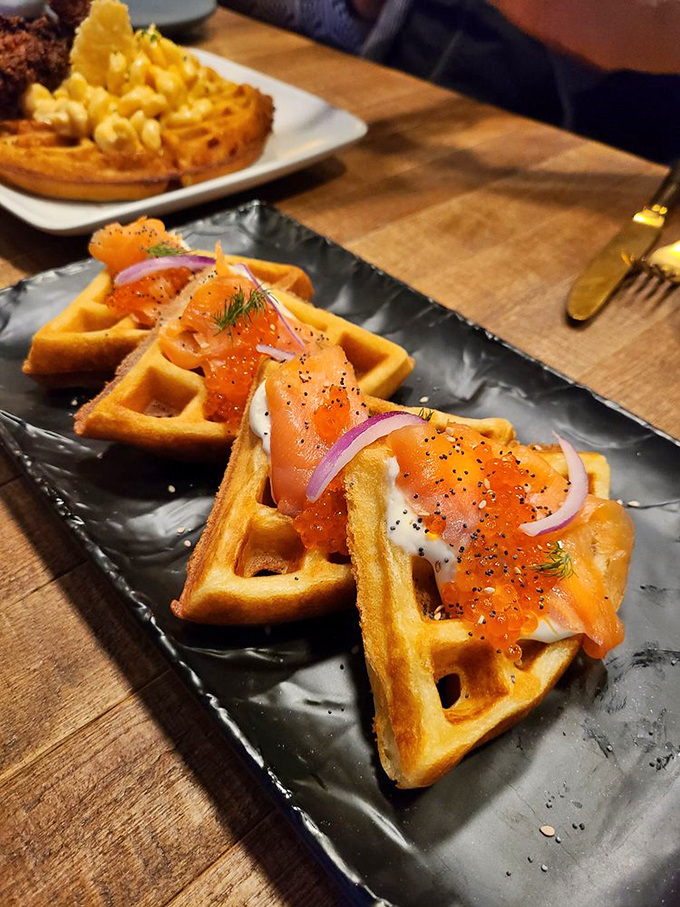 Smoked salmon finds its perfect match atop crisp waffles, with red onion and capers adding bright notes to this brunch masterpiece.