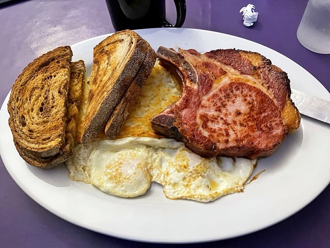 Breakfast of champions! A thick-cut smoked pork chop alongside perfectly cooked eggs &ndash; the kind of hearty morning meal that fueled generations before "brunch" was trendy.
