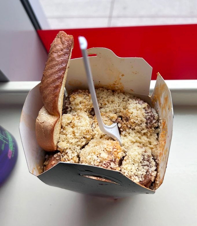 A hearty portion of spaghetti and meatballs nestled beside crusty bread &ndash; comfort food that doesn't need fancy plating to make your mouth water.