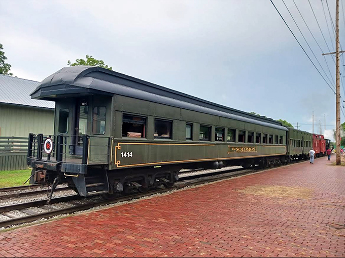 The Solomon passenger car waits patiently, its green exterior promising journeys where the rhythm of the rails becomes your heartbeat.