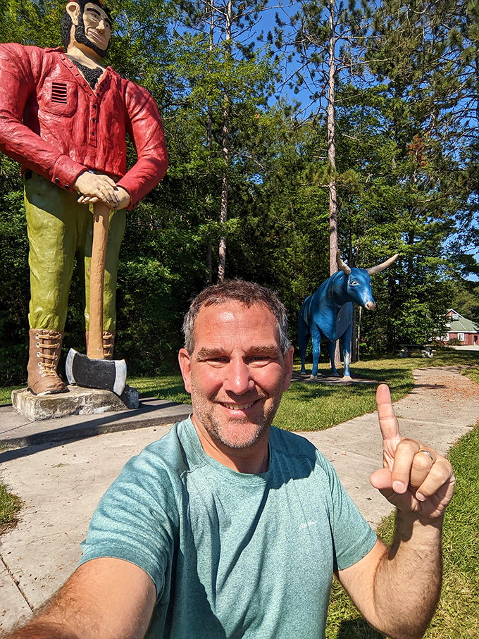 A happy traveler gives the thumbs-up after discovering this whimsical roadside attraction, proving good humor is still alive on American highways.