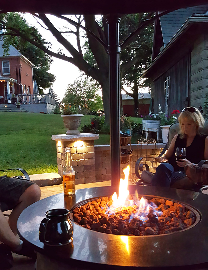 Visitors: Evening magic unfolds around the fire pit, where stories flow as freely as the wine while flames dance beneath the Michigan sky.