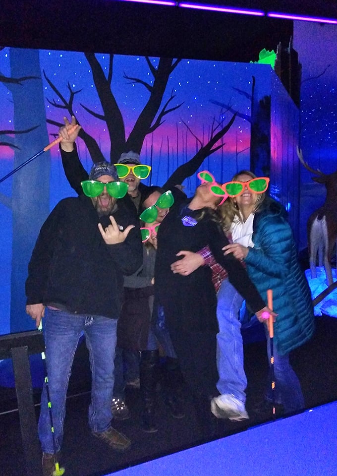 Oversized neon glasses transform visitors into glowing creatures of the night, perfect for capturing that "we're definitely not normal" moment.