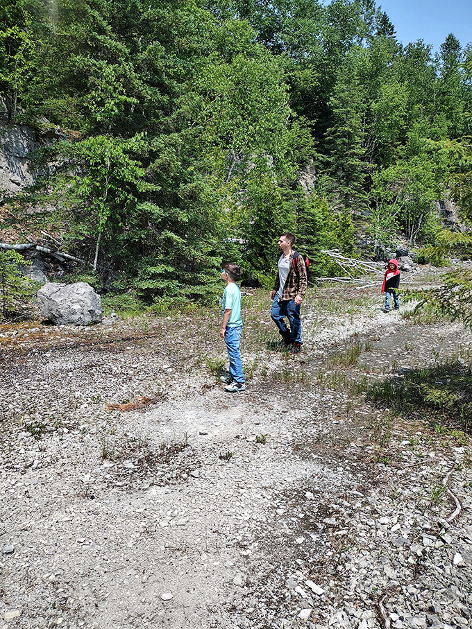 Young explorers discover history firsthand, their curiosity echoing across the quarry landscape just as workers' voices once did.