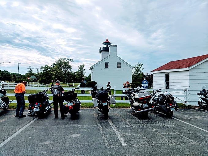 Motorcycle enthusiasts gather where land meets lake, proving lighthouses attract all types of modern-day adventurers seeking their own beacon.