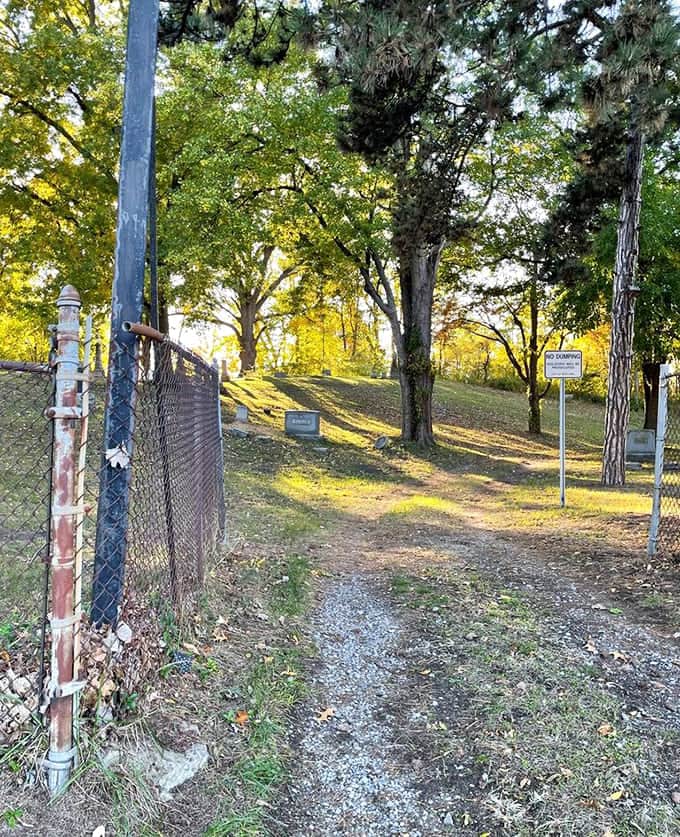 The gravel walkway winds through the cemetery like a gentle invitation to explore history at your own leisurely pace.