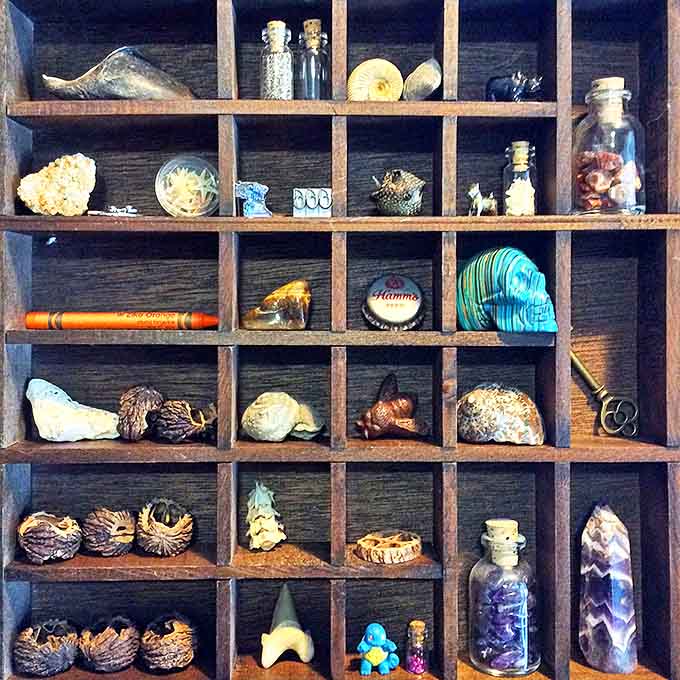 This wooden shadow box transforms ordinary objects into a museum-worthy collection, each compartment telling its own tiny story.