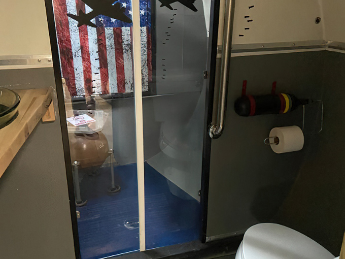 The bathroom might be the most impressive transformation, complete with shower and patriotic decor.