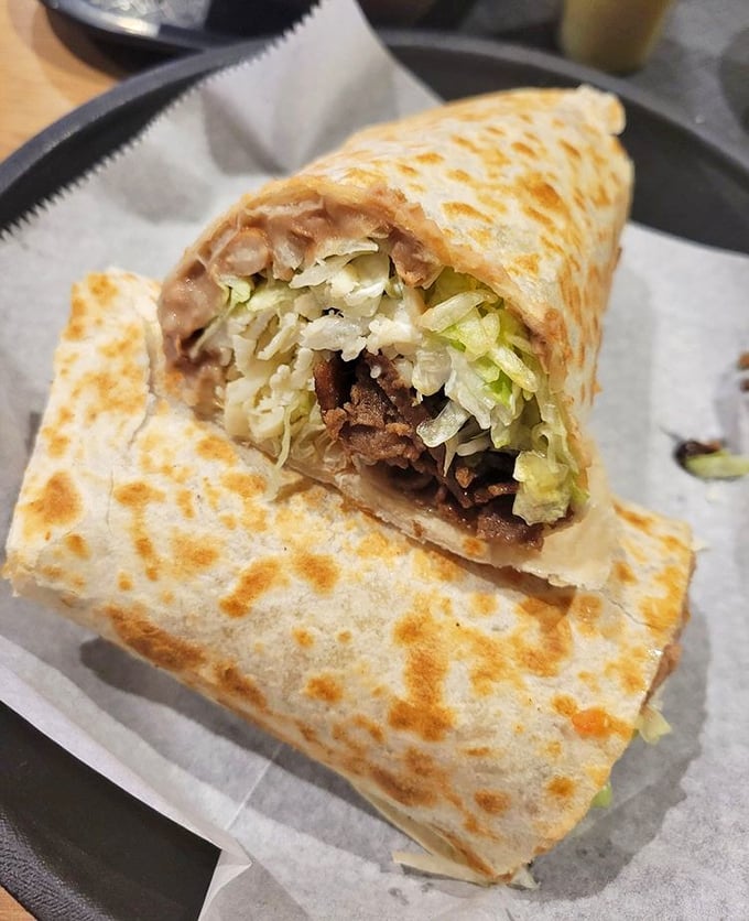 The steak burrito reveals its secrets when sliced &ndash; layers of perfectly seasoned beef, rice, and beans that would make a geologist weep with joy.
