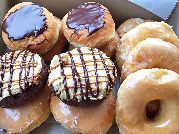 The chocolate-topped treasures sit alongside classic glazed varieties, creating the kind of difficult decisions worth agonizing over.