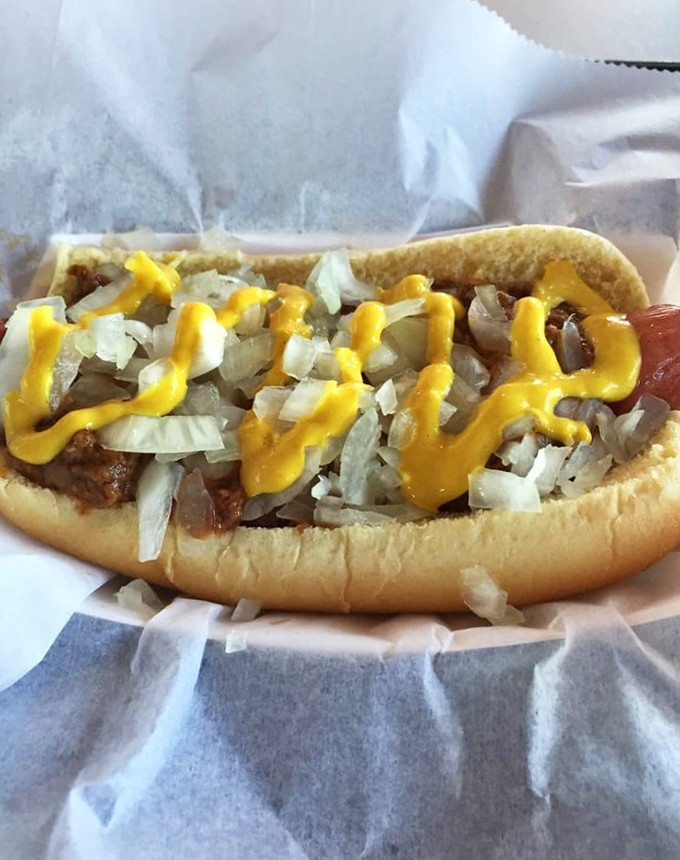 Every bite delivers that perfect combination &ndash; the snap of the natural casing, rich meat sauce, sharp onions, and tangy mustard in harmonious balance.