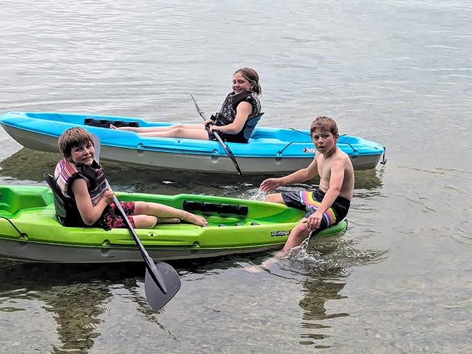 Colorful kayaks bring human-sized joy to the vast lake. Nothing says "vacation" quite like paddling through crystal clear waters!