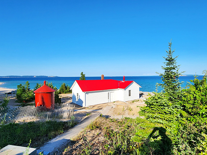 Keeper's quarters: This charming white building with its bright red roof once housed the brave souls who kept the light burning through fierce Michigan winters.