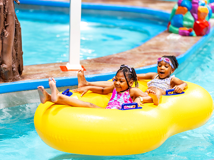 Pure joy captured: young adventurers float in a yellow inner tube, their expressions worth a thousand "are we there yet?" car rides.