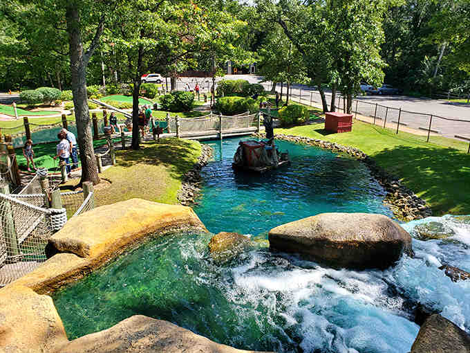 Crystal-clear waters flow through carefully engineered channels, creating hazards that transform simple putting into strategic aquatic challenges.