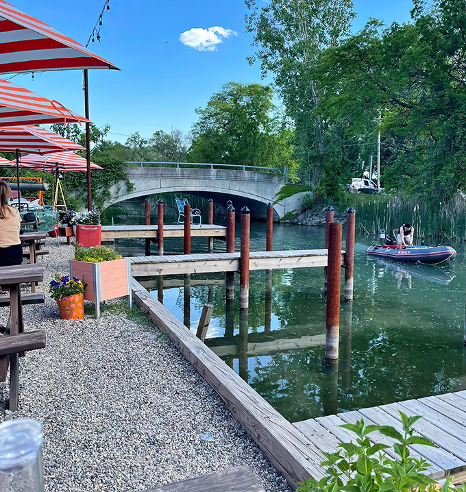 Colorful umbrellas and waterfront tables invite canal explorers to dock their kayaks for a well-earned refreshment break.