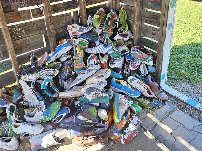 A mountain of mismatched shoes tells a thousand walking stories, each pair representing journeys that somehow led here.