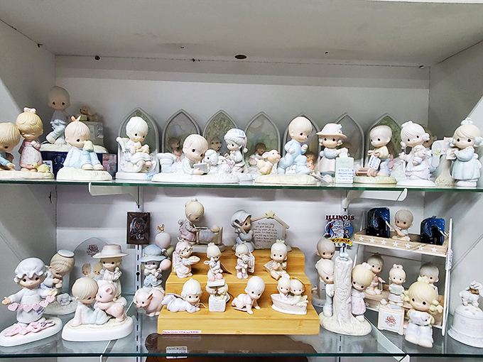 Precious Moments figurines gather in formation, their signature teardrop eyes either melting hearts or raising questions about anatomically improbable head-to-eye ratios since the 1970s.