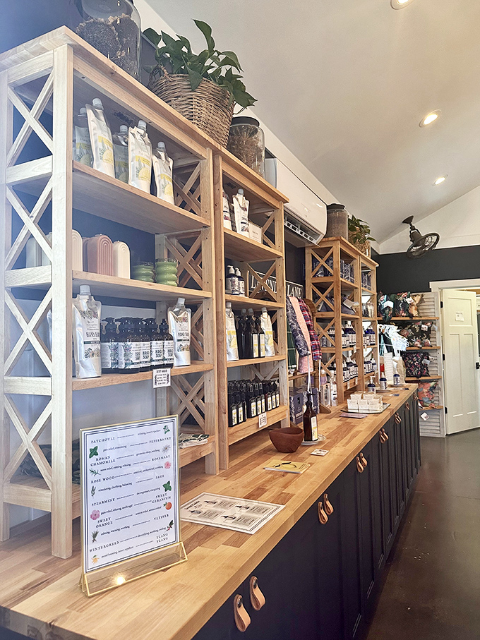 Lavender treasures line wooden shelves like purple gold, tempting visitors with fragrant souvenirs that bring the garden home.