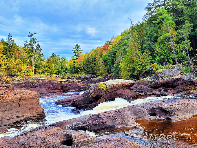 Autumn transforms the Black River corridor into a painter's palette of crimson, gold and russet against the rushing waters.