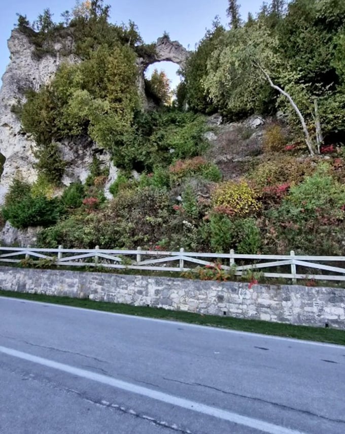 White limestone formations stand guard along the roadway, sculpted by time and water into nature's own art installation.