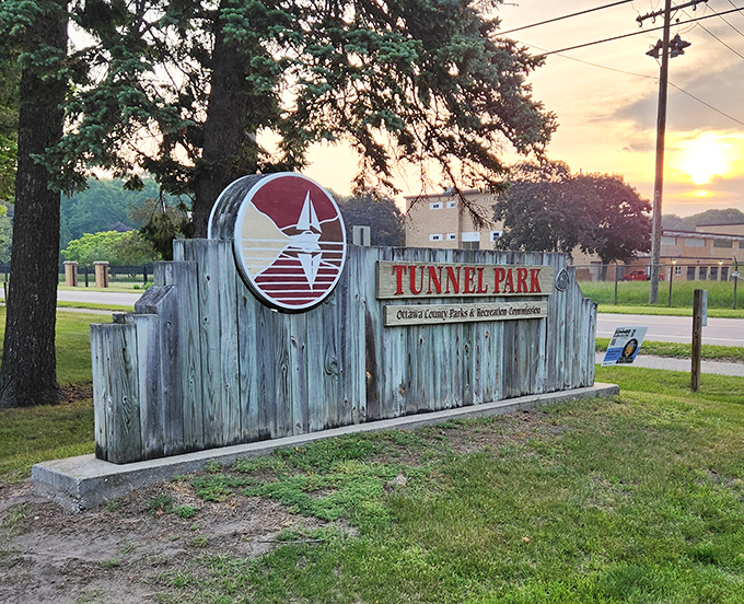 The rustic wooden sign welcomes visitors to Tunnel Park, a hidden gem along Michigan's spectacular western shoreline.
