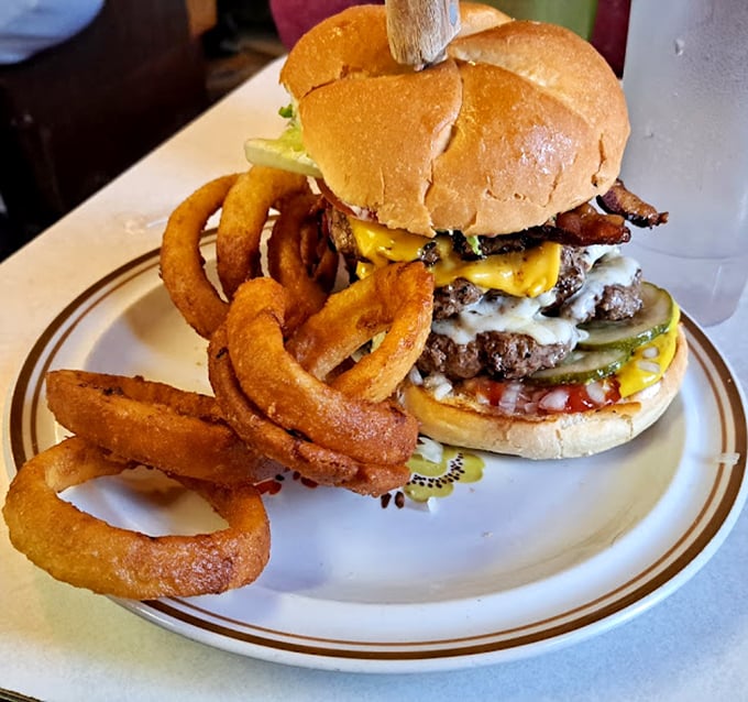 The double cheeseburger defies physics with its impressive height, yet somehow remains perfectly manageable to eat – a towering achievement in burger architecture.