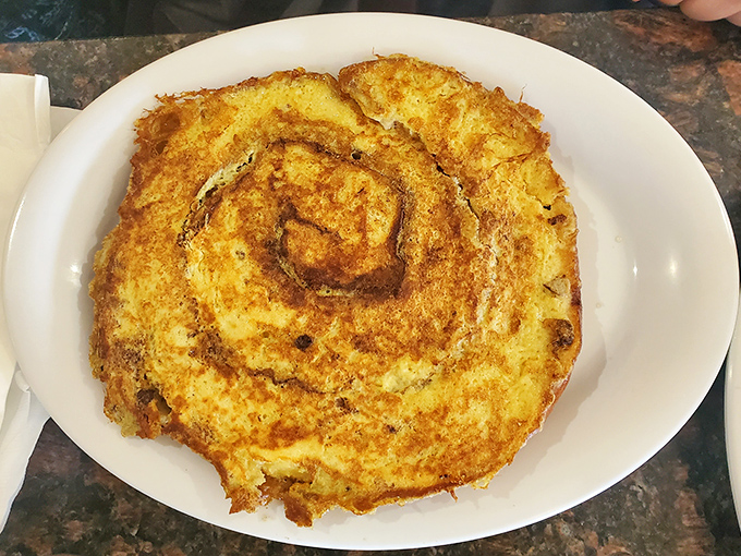 The perfect breakfast duet: cinnamon roll French toast with a side of crispy bacon for that sweet-savory harmony.
